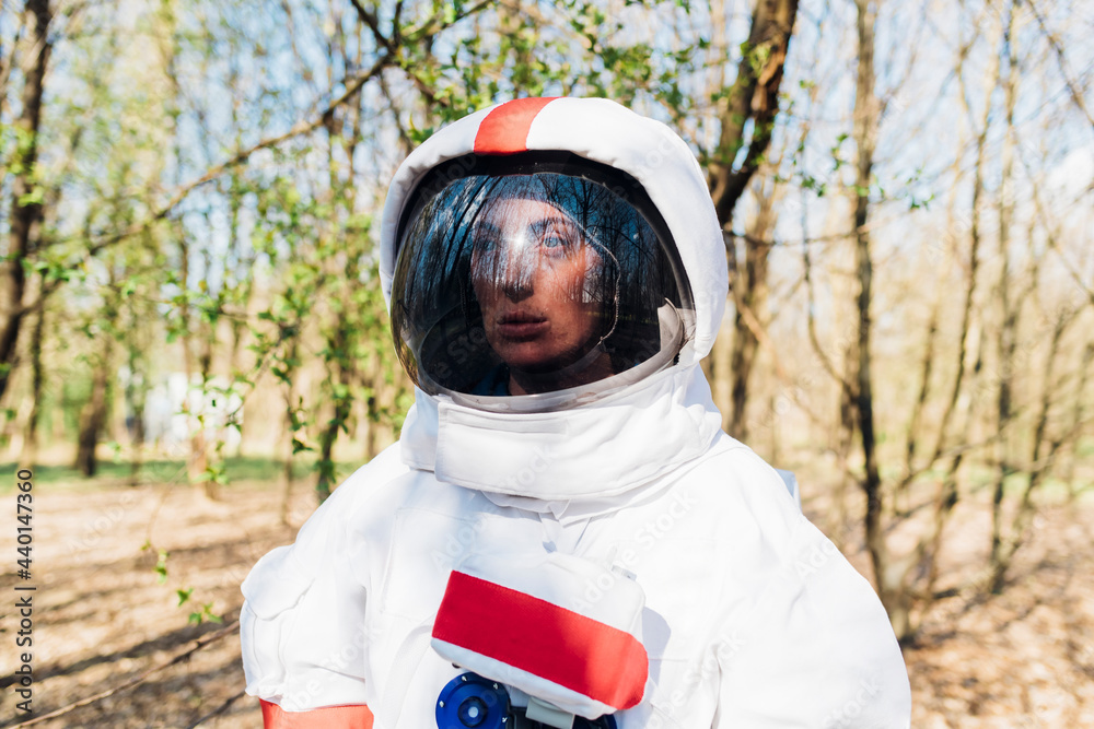 Thoughtful female explorer in space suit and helmet at forest Stock ...