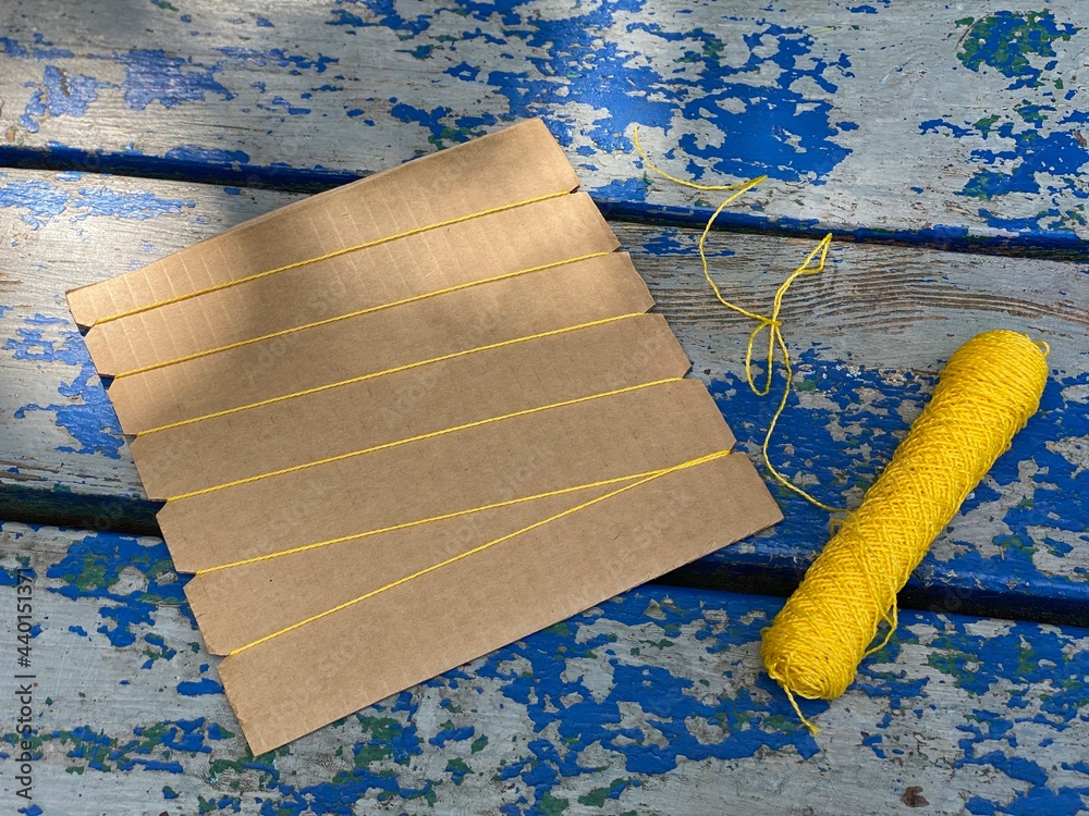 square-shaped cardboard and yellow cord a blue background, kids craft ...