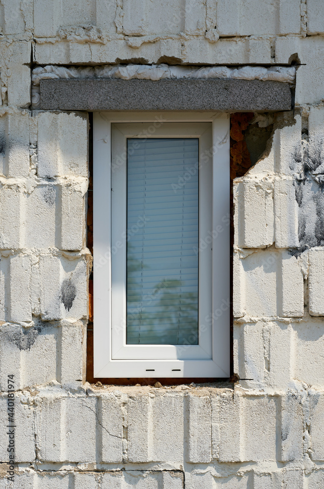 Unprofessionally installed window in the facade of a house with ...