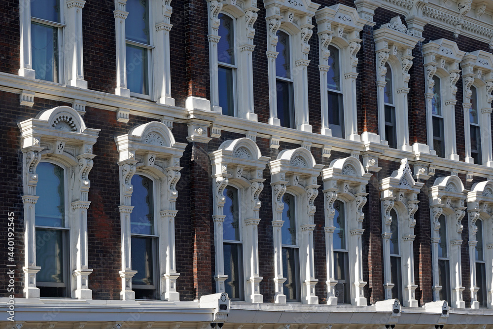 Old fashioned 19th century building facade with ornate window frame ...