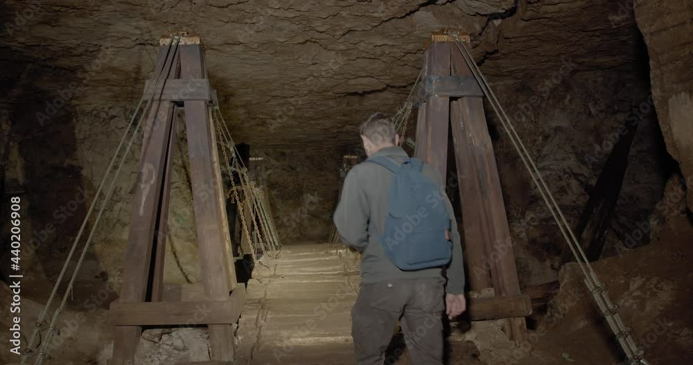 Video „A lone traveler walks across a dangerous bridge inside a dark ...