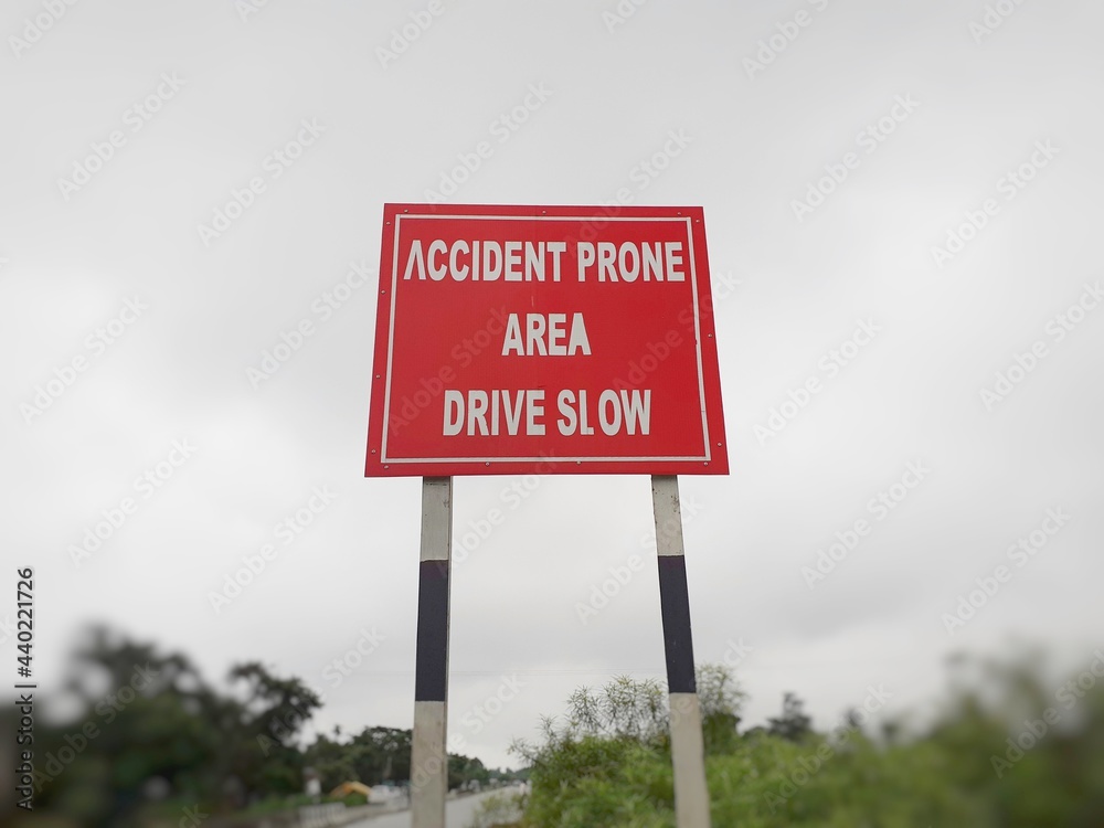 Drive slow, accident prone area sign board on the highway, roadside ...
