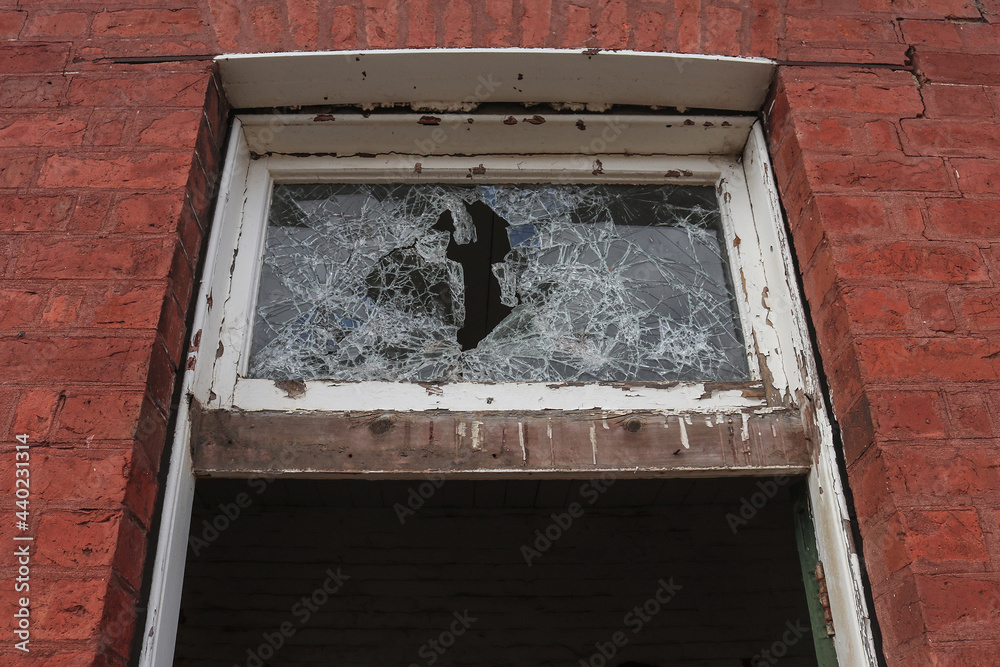 vandalised broken glass window in a derelict industrial building Stock ...