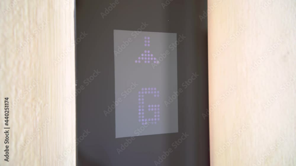 Digital display in the elevator which rises up on floor with an arrow ...
