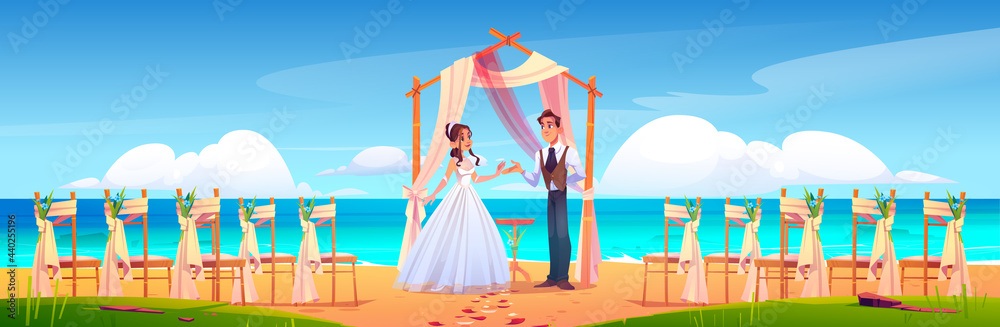 Beach wedding ceremony with newlywed couple, floral arch and chairs on ...
