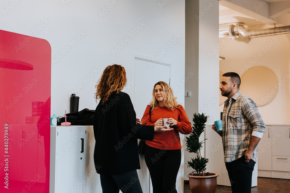 Coworkers talking at break time Stock Photo | Adobe Stock