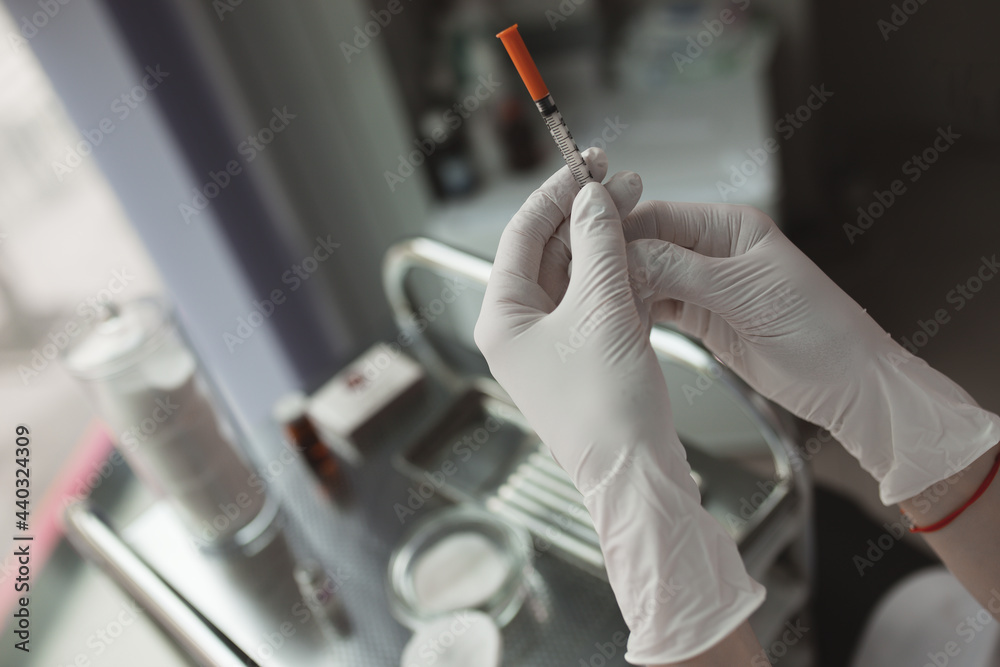 Doctor filling syringe with medication, closeup. Vaccination and ...