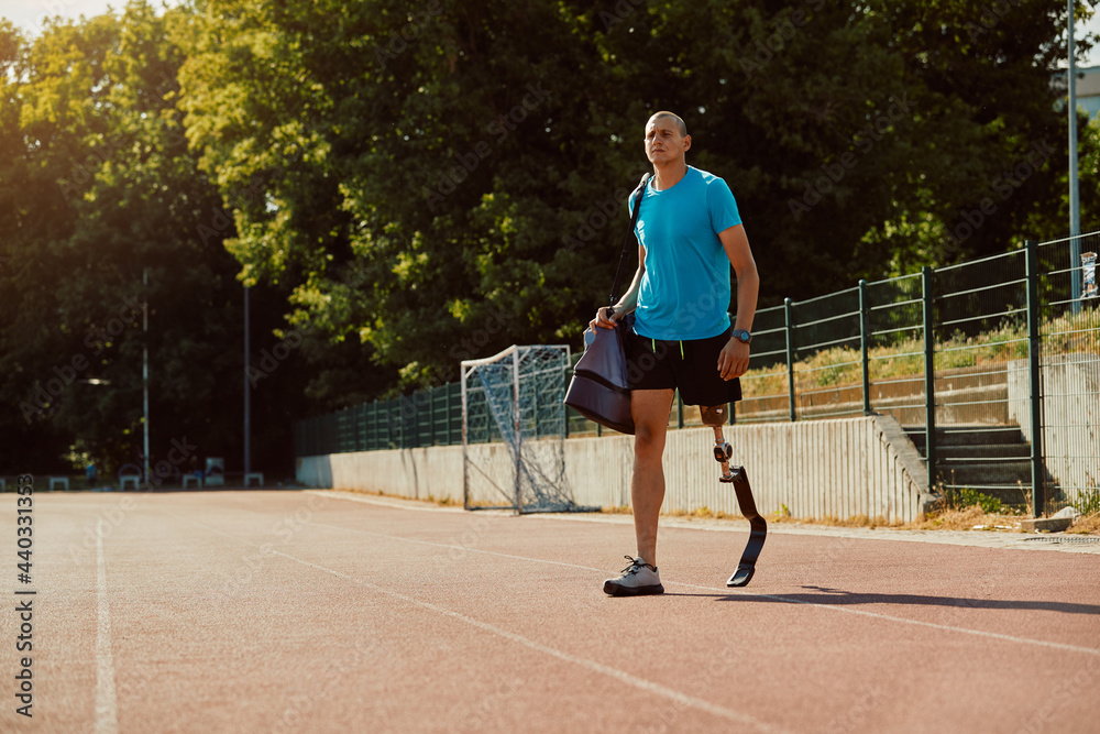 Disabled male runner with prosthetic leg comes to practice at the ...