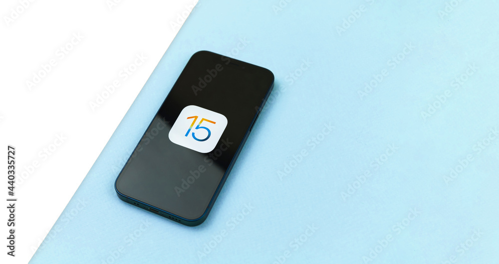 Apple iPhone software update, iOS 15 icon on the screen, office desktop ...