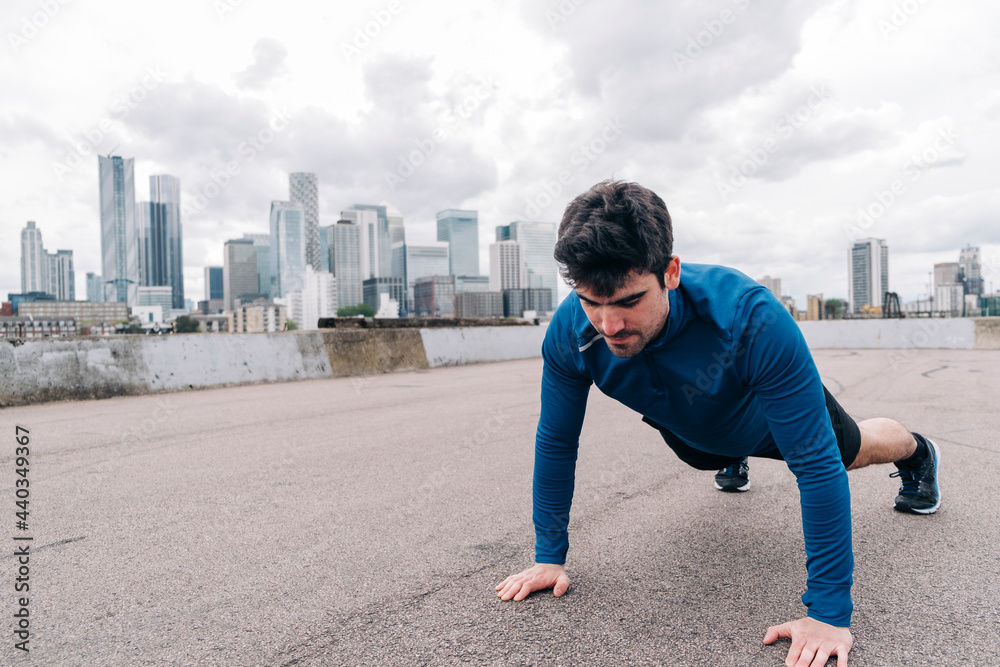 Man doing pushups in London city, Fitness male training push-ups ...