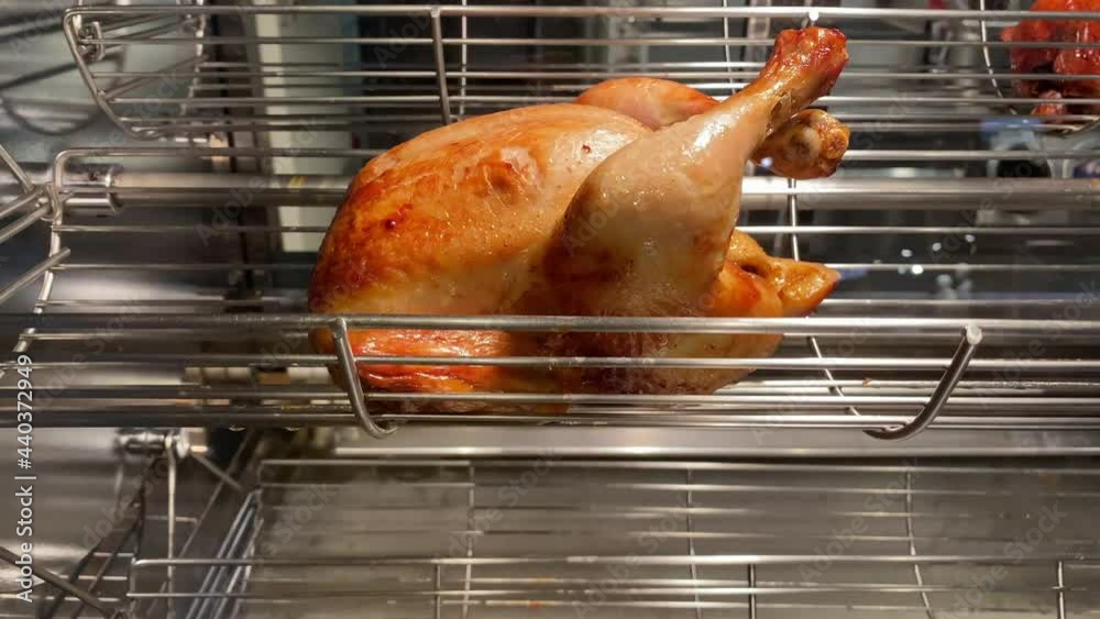 Rotating machine are grilled whole chicken. Roasted chickens in a row ...