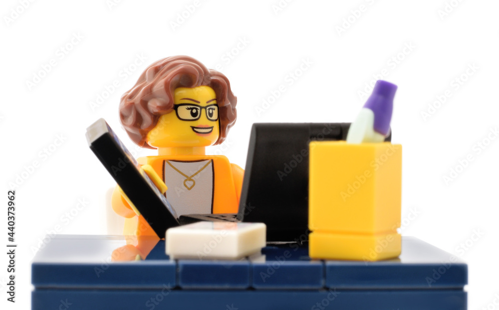 Lego minifigure of businesswoman or office manager with pen, smartphon ...