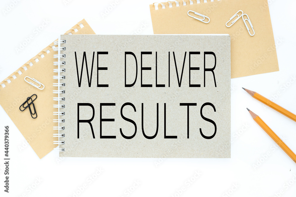 We deliver results ! text on notepad on white background Stock Photo ...