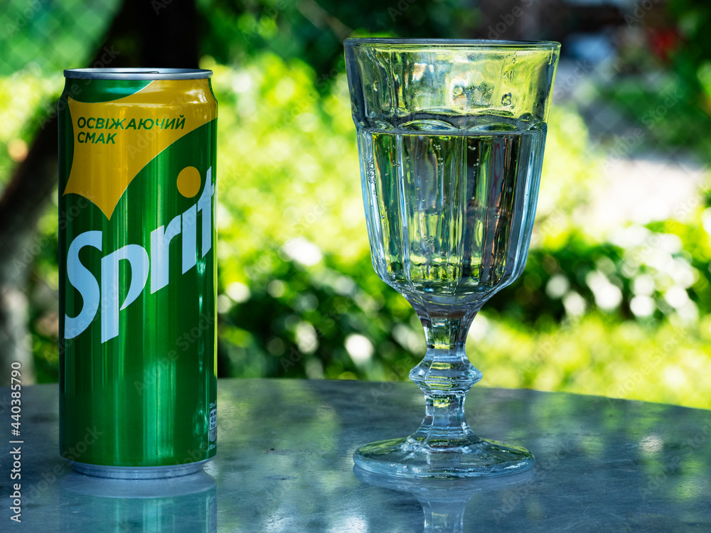In this photo illustration can and glass of Sprite on a marble table in ...