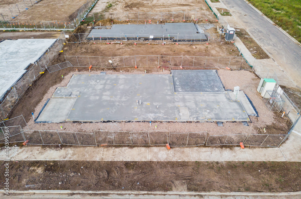 An aerial view of a freshly laid concrete house slab in a new ...