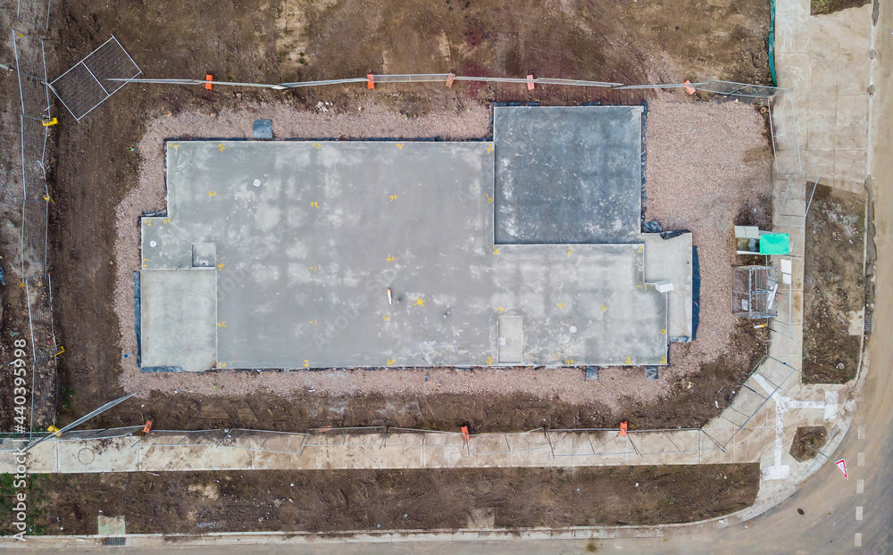 An aerial view of a freshly laid concrete house slab in a new ...