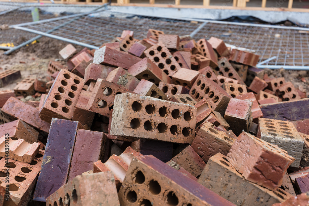 A pile of bricks on a house construction site in the suburbs of ...