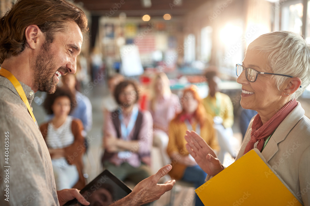 Presenters in a good mood after well done presentation in the office ...