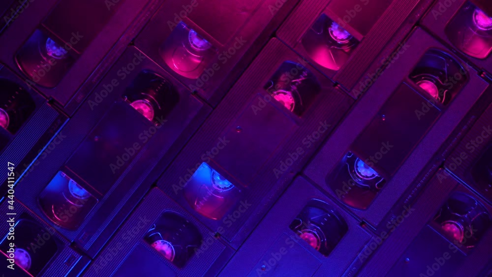 Retrofuturistic background of real VHS cassette pattern sliding to the ...