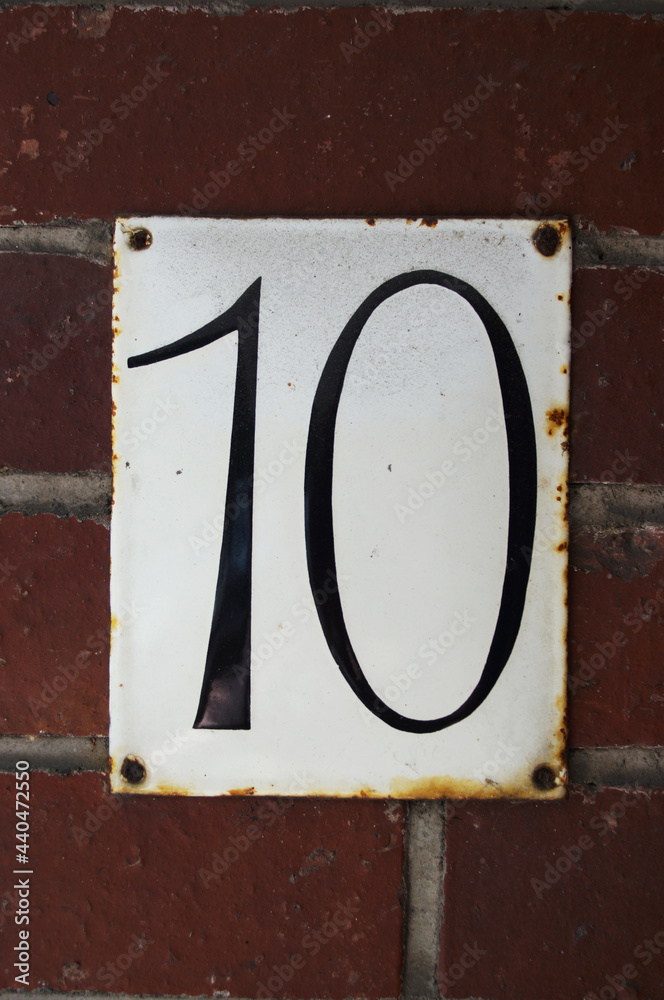 House number "10" attached to a brick wall Stock Photo | Adobe Stock