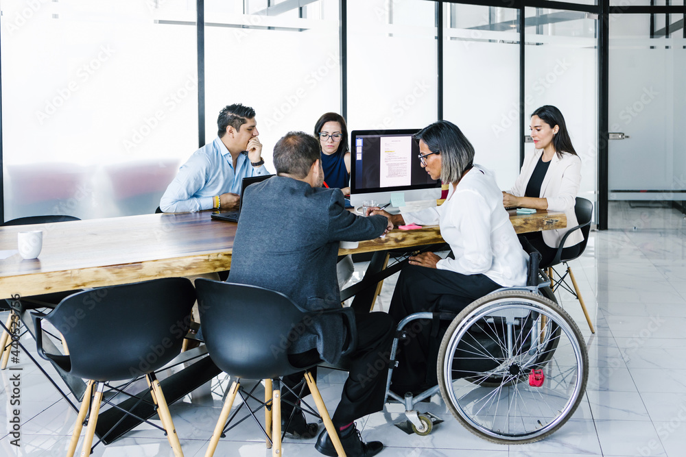 Latina handicapped transgender woman with business people working on ...