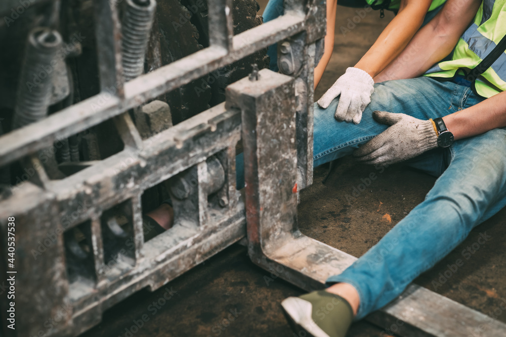 injured Asian man worker after accident in a old car parts warehouse ...