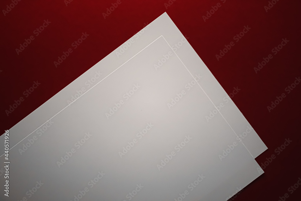 Blank A4 paper, white on red background as office stationery flatlay ...