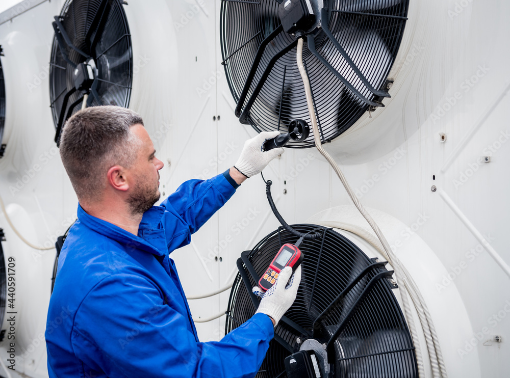 Testing with an anemometer of an axial fan of the condensing unit Stock ...