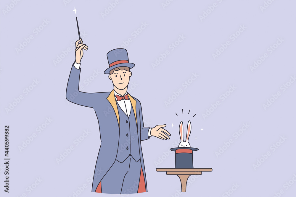 Magician making trick during work concept. Young smiling man magician ...