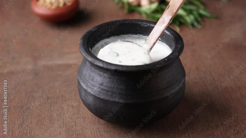 Pouring serving Spiced buttermilk , chaas , chaach , moru , sambharam ...