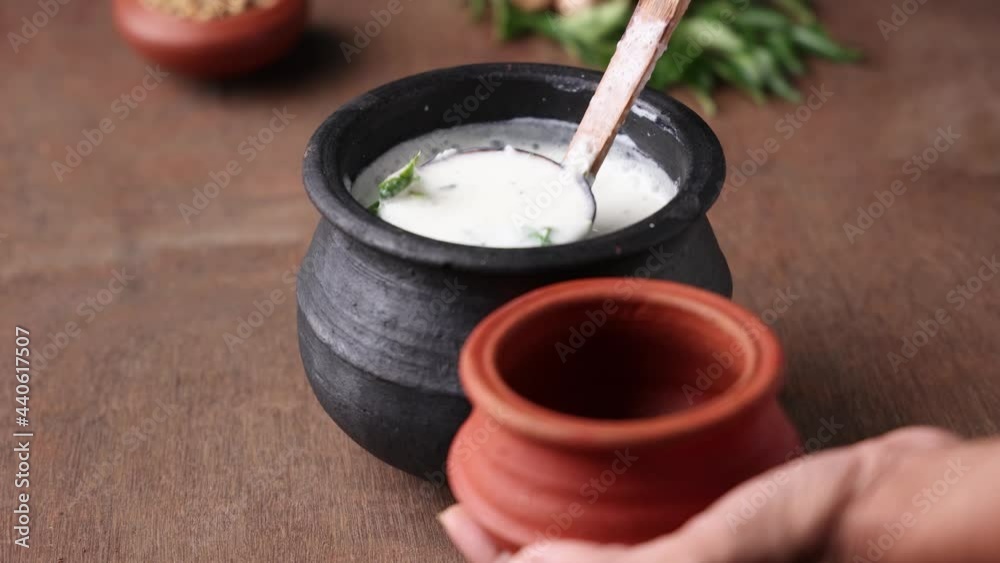 Pouring serving Spiced buttermilk , chaas , chaach , moru , sambharam ...