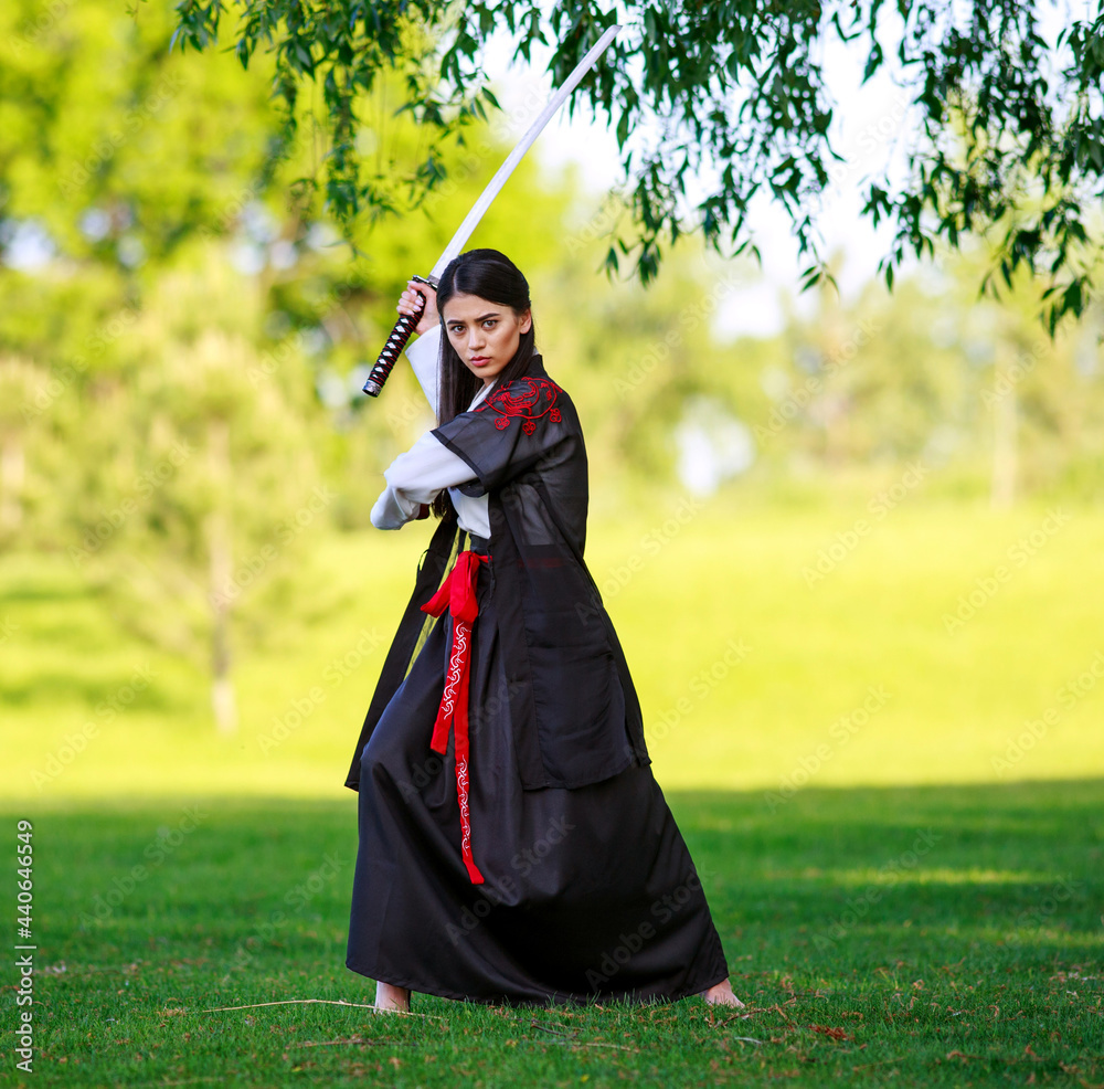 Young asian woman in traditional kimono trains fighting techniques with ...