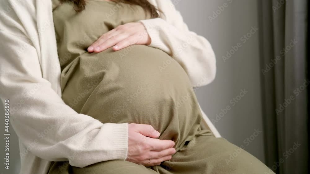 4k Pregnant expectant mother caressing her belly. Woman hands touching ...