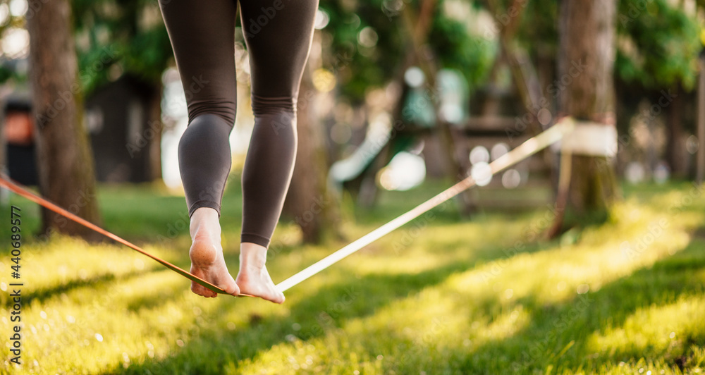 Slacklining is a practice in balance that typically uses nylon or ...