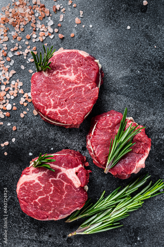 Fillet Mignon tenderloin raw meat beef steaks on butchery table. Black ...