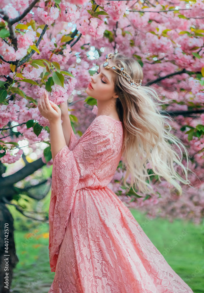 Fantasy happy woman princess walks in spring blooming garden hugs ...