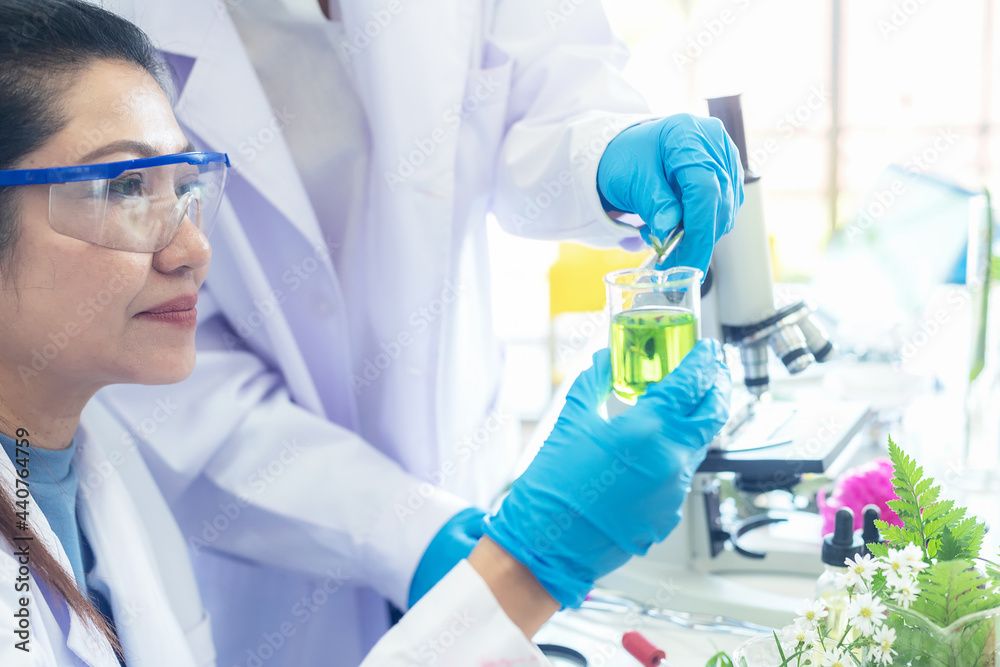 Asian Woman and team science lab research for Natural alternative herb ...