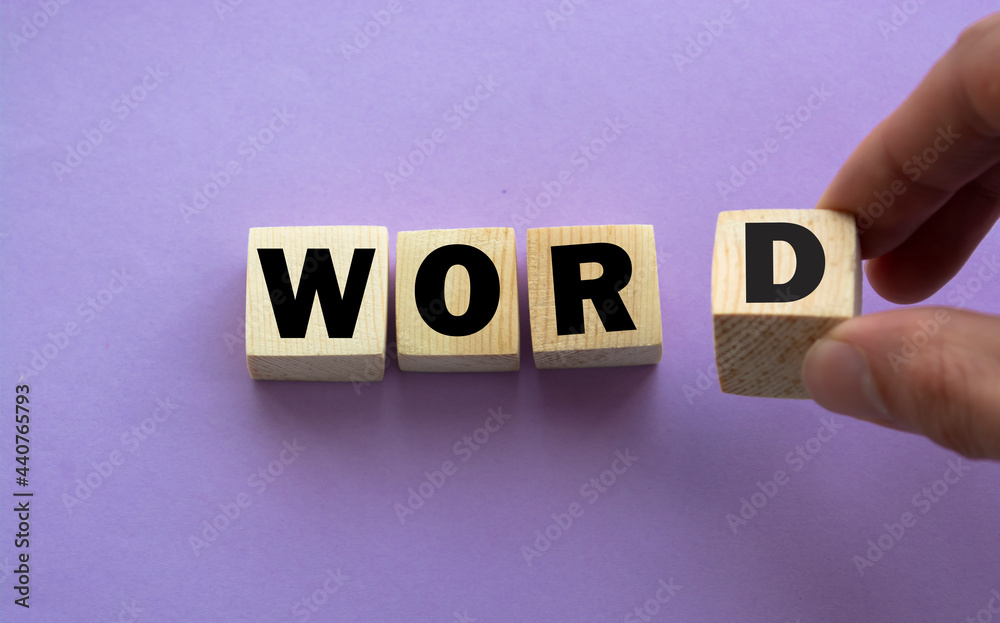Man puts a wooden blocks with the inscription Word. The structural unit ...