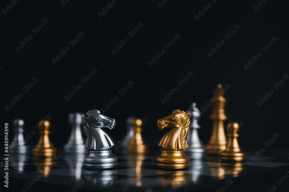 Gold king winner surrounded with silver chess pieces on chess board ...