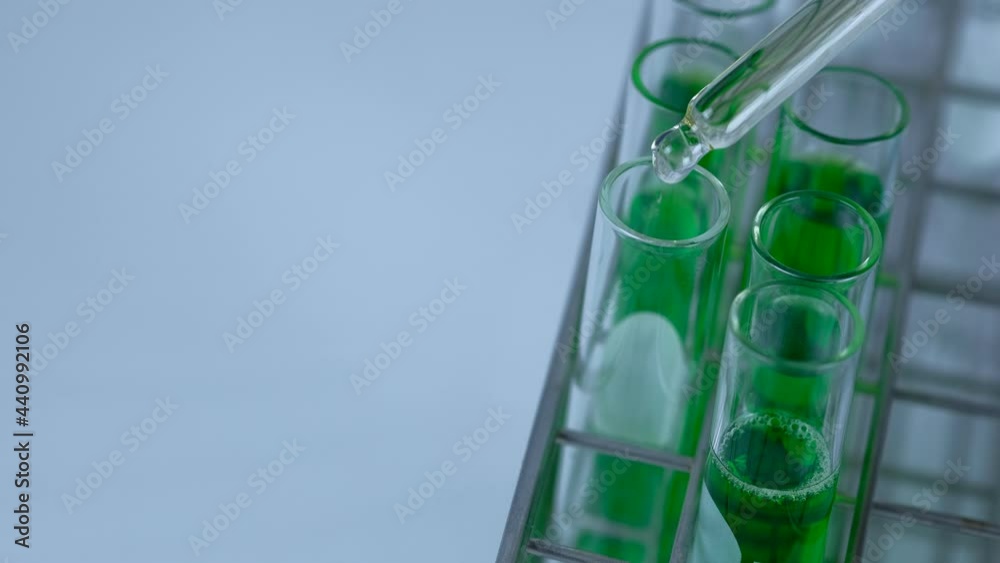 Scientist is preparation and dropping the green chemical solution in ...