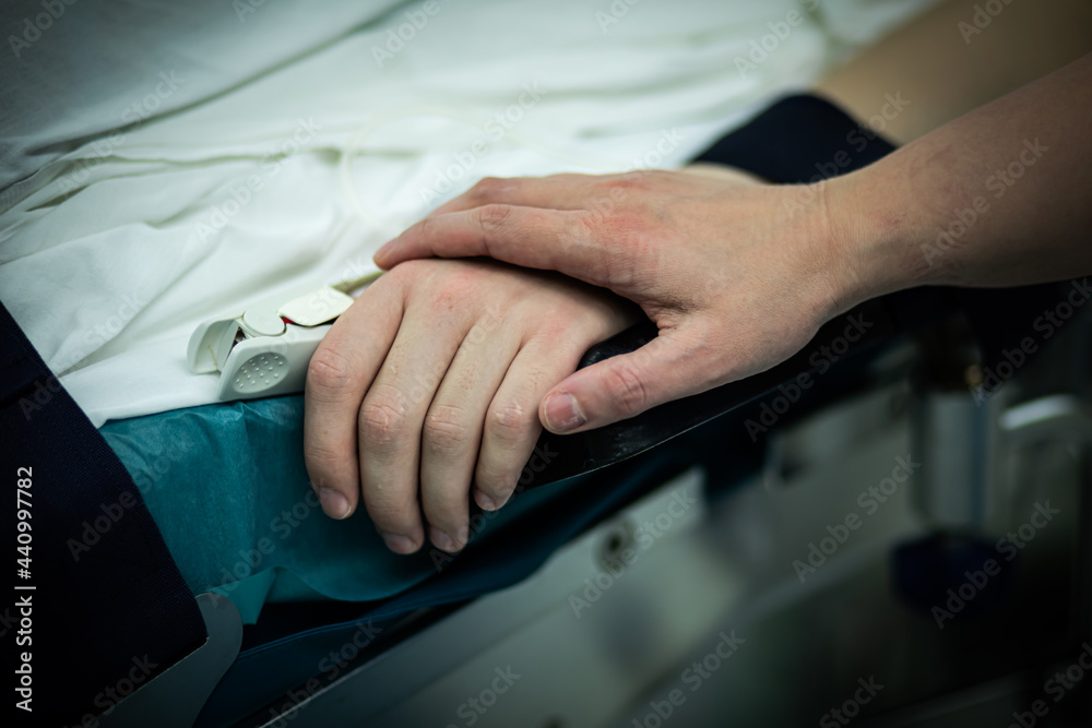 the patient's hand in the doctor's hands, the doctor supports the ...