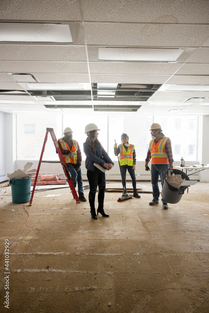 Construction workers on office renovation site Stock Photo | Adobe Stock