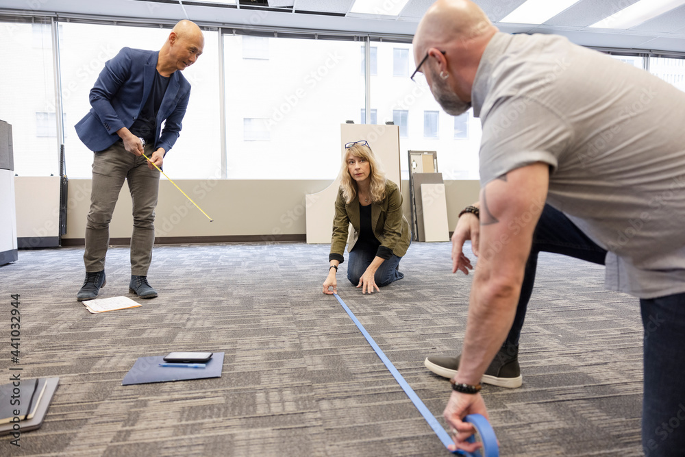 Architect and new owners laying out floor plan in office Stock Photo ...