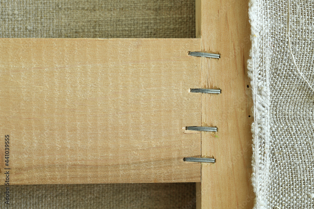 Wooden bars are connected with metal staples. A stretcher for a picture ...