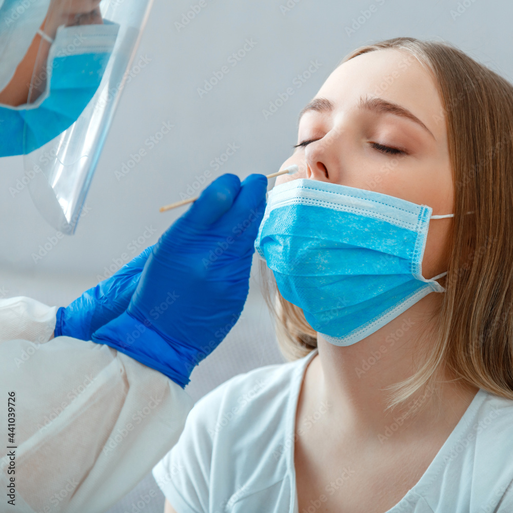 Doctor taking nasopharyngeal culture to woman patient. Nurse take ...