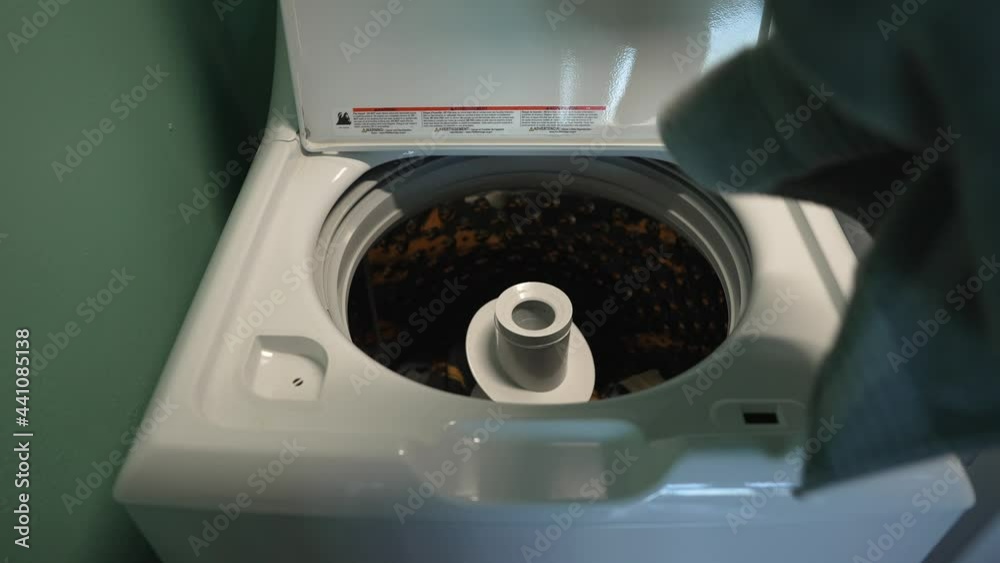 This slow motion video shows a top view of someone throwing laundry and ...