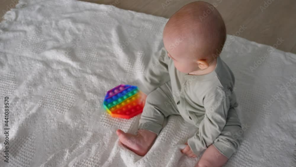 a child plays with a clapping fidget. popular children's flexible ...
