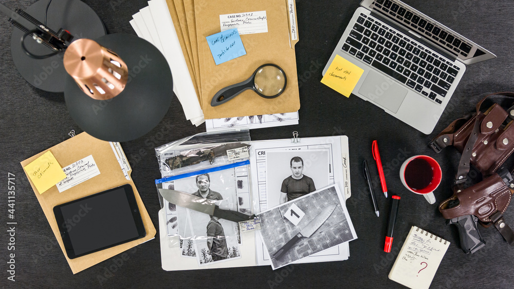 Police looking photos, documents and physical evidence. View from above ...