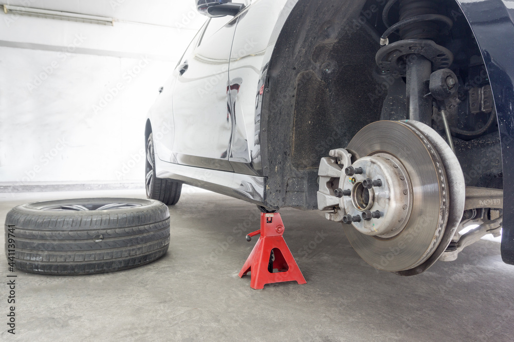 Car lifting it off the ground by Jack stands during car wheel ...