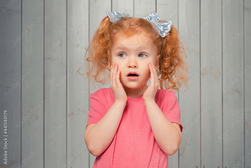 Shocked and scared redhead little girl 4-6 years old, staring startled ...